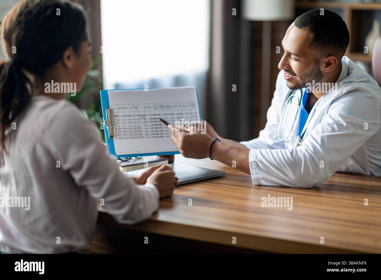 Handsome black man in white workwear doctor having conversation with ...