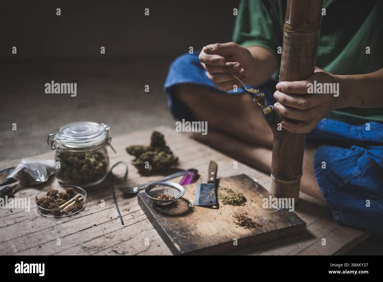 A person man sits alone in a dark room smoking marijuana, Drug addict ...