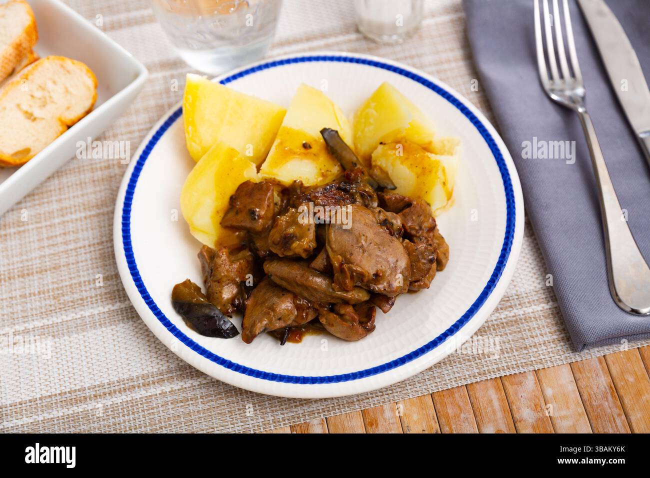 Fried rabbit liver served with boiled potato Stock Photo - Alamy
