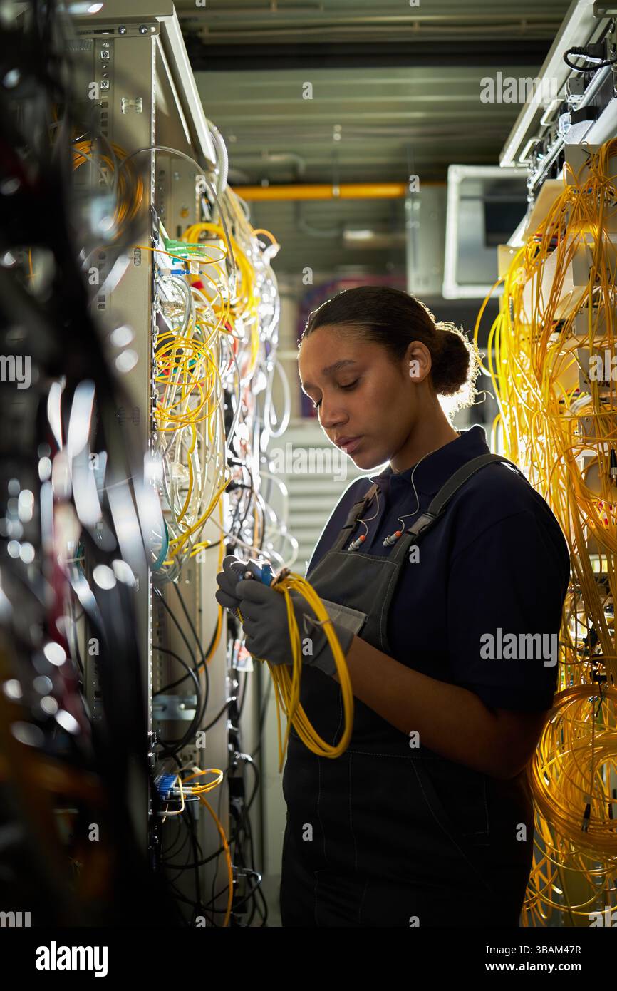 Technician Working on Server Room Cable Management Stock Photo - Alamy
