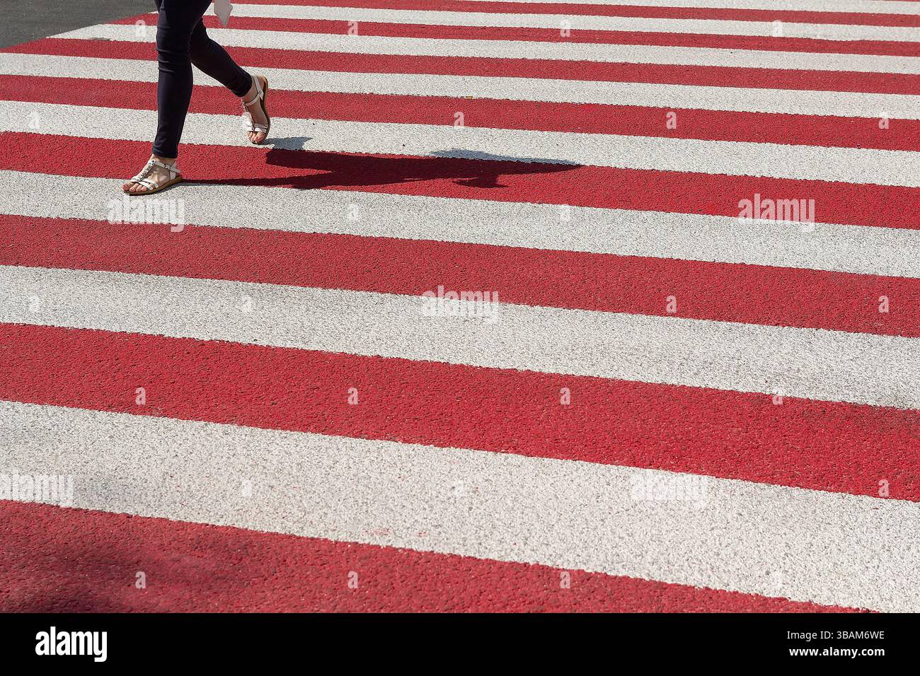 Legs of the woman crossing the street on the above-ground crossing ...