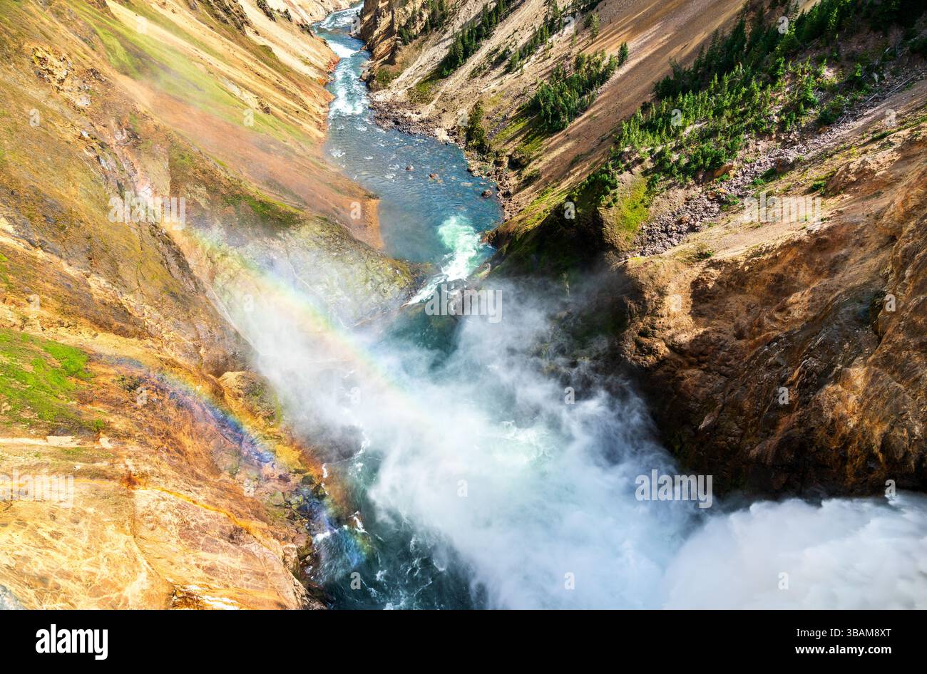 Mist from the powerful Lower Falls in Yellowstone National Park creates ...