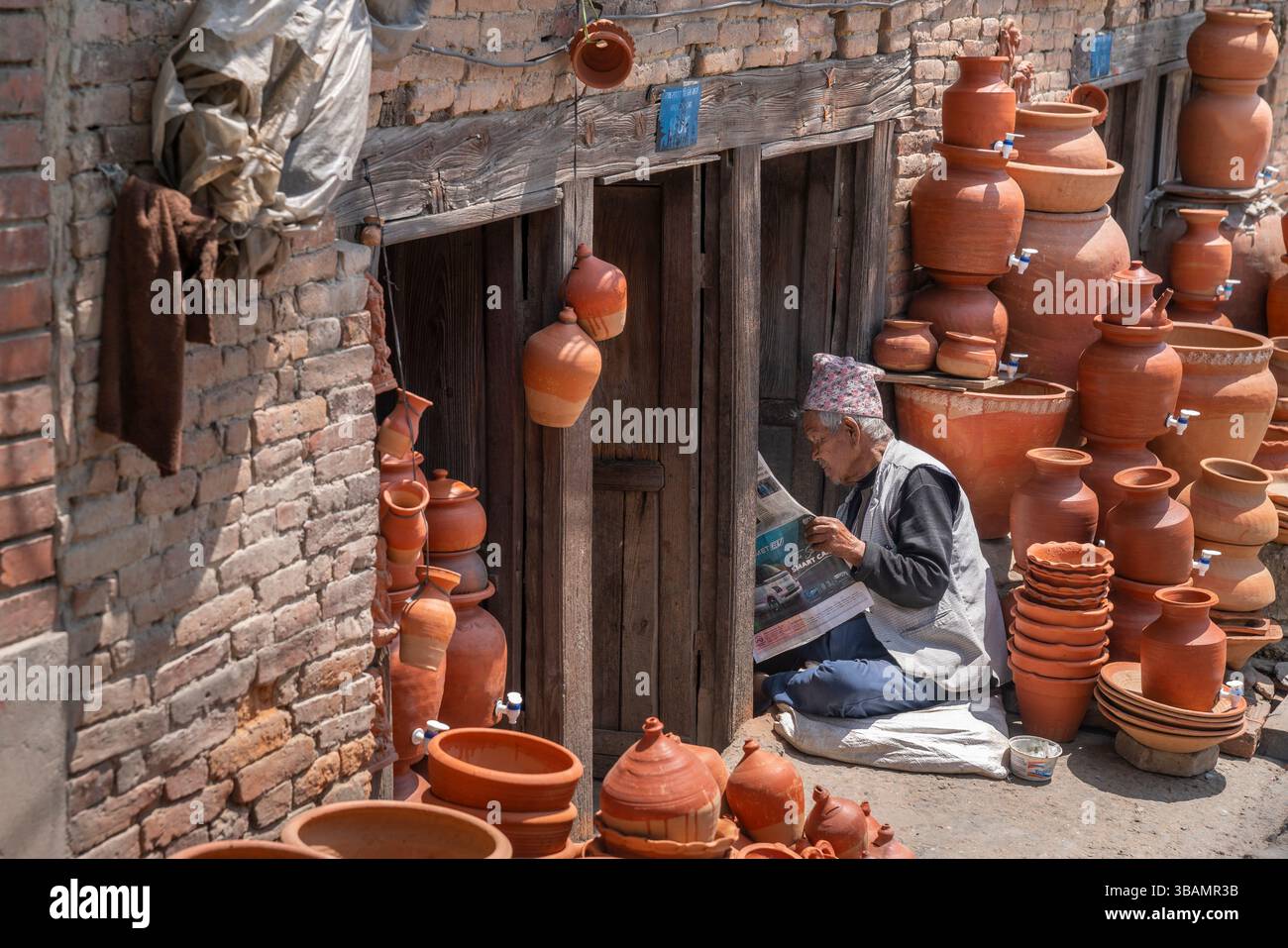 Nepali potter working on the pottery square in Bhaktapur, Nepal ...