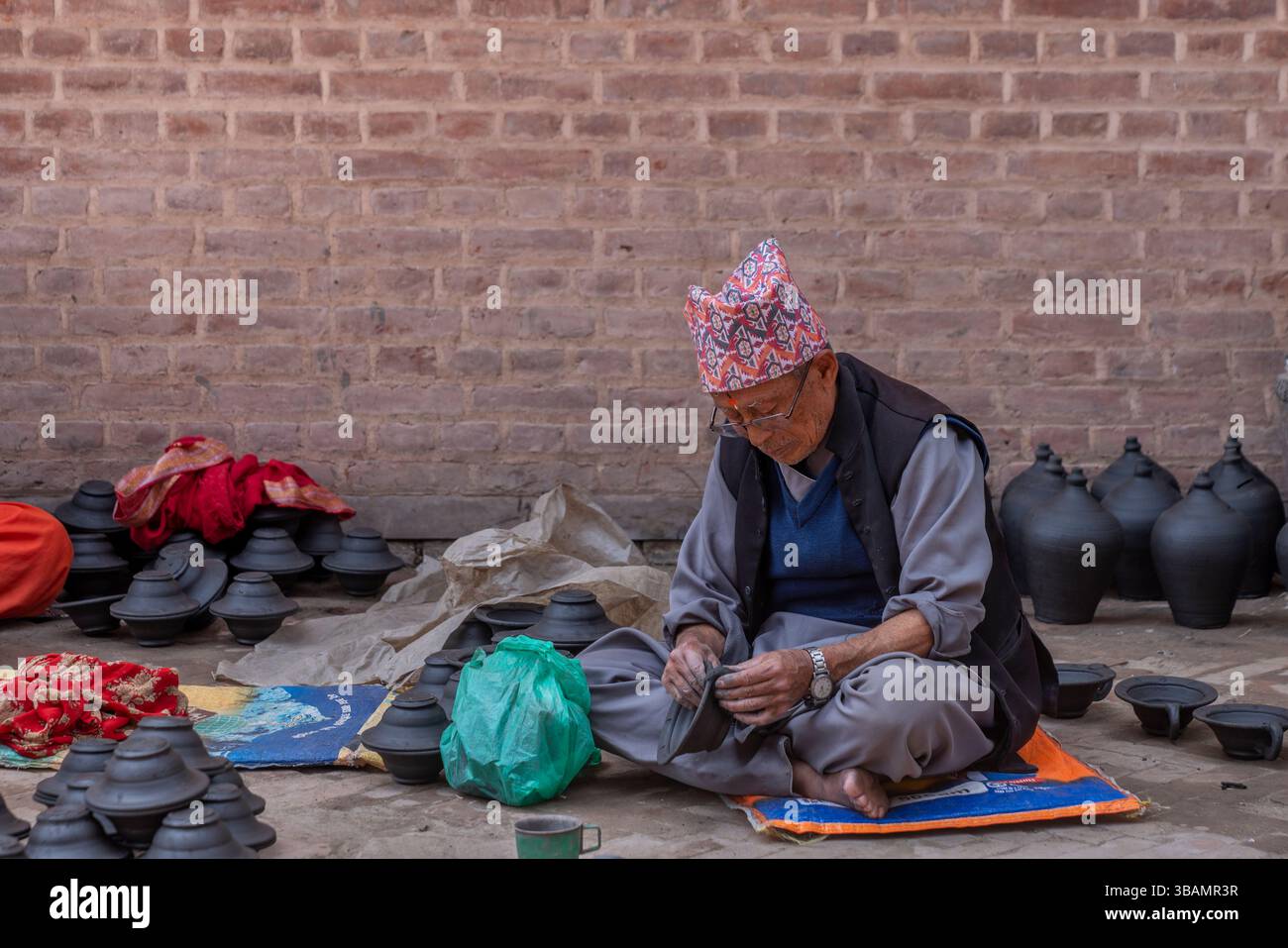 Nepali potter working on the pottery square in Bhaktapur, Nepal ...