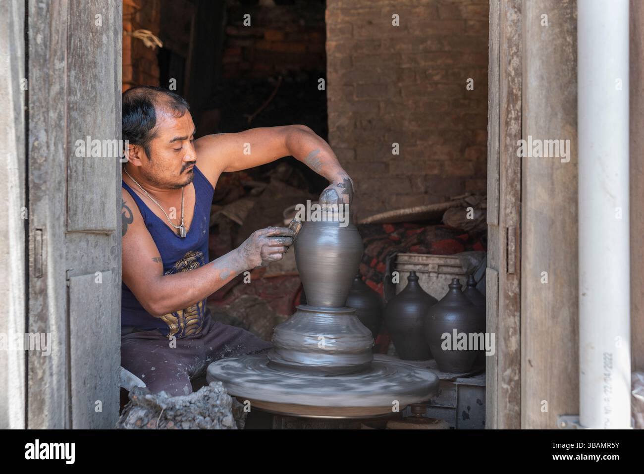 Nepali potter working on the pottery square in Bhaktapur, Nepal ...