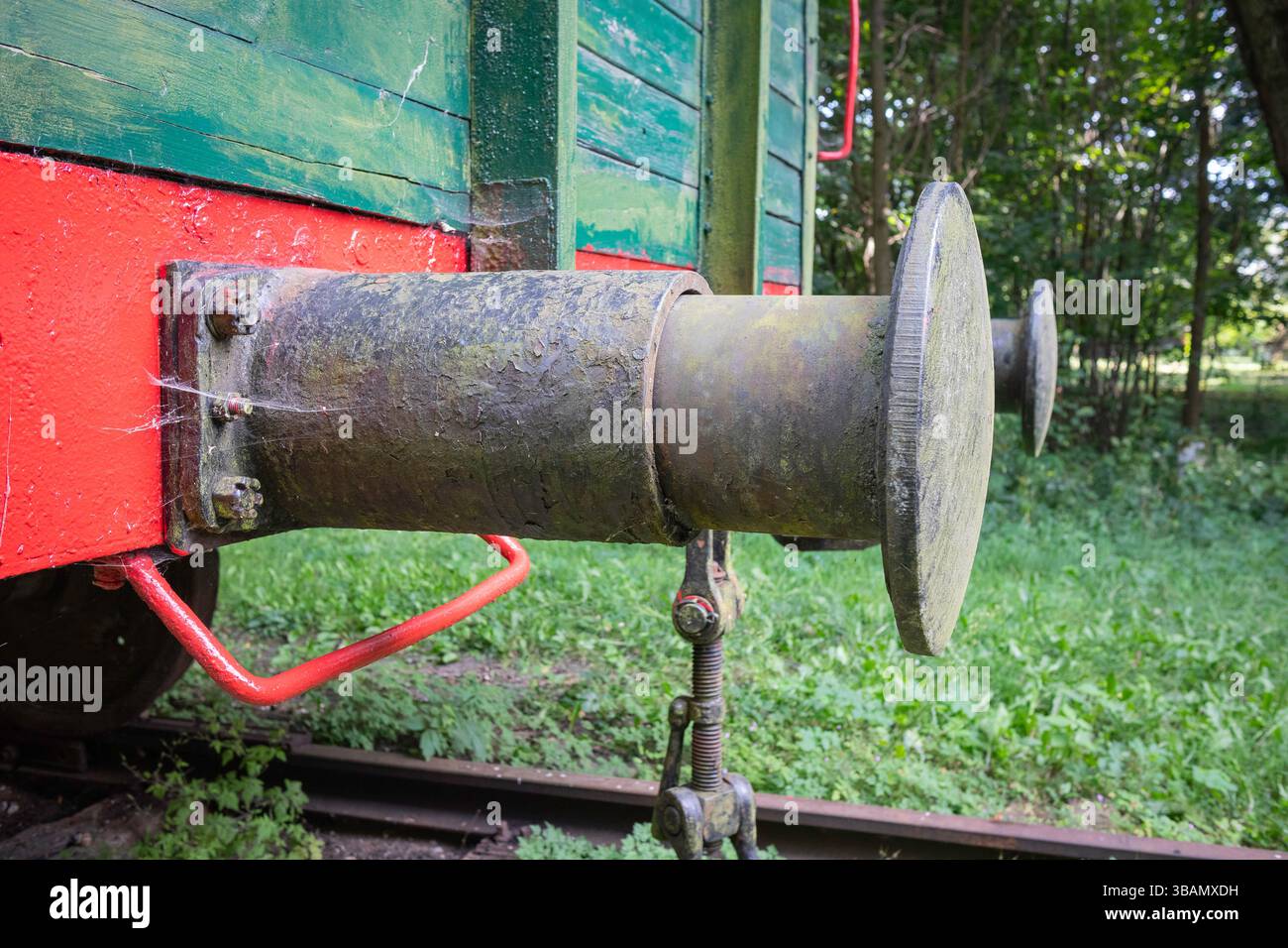 A train car with a rusty bolt on the front. The bolt is covered in dirt ...