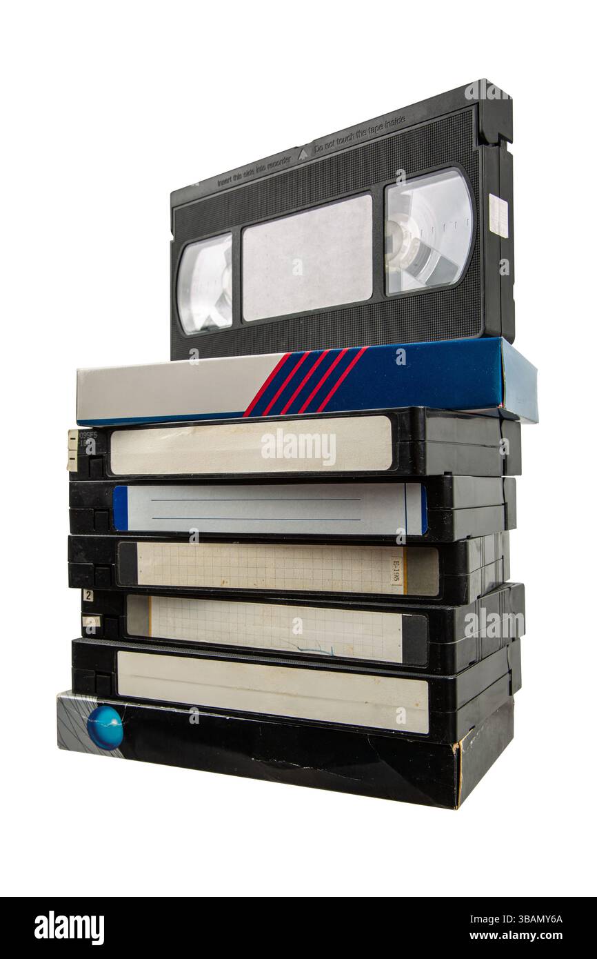 A stack of nine VHS tapes with varied labels, some handwritten and worn ...