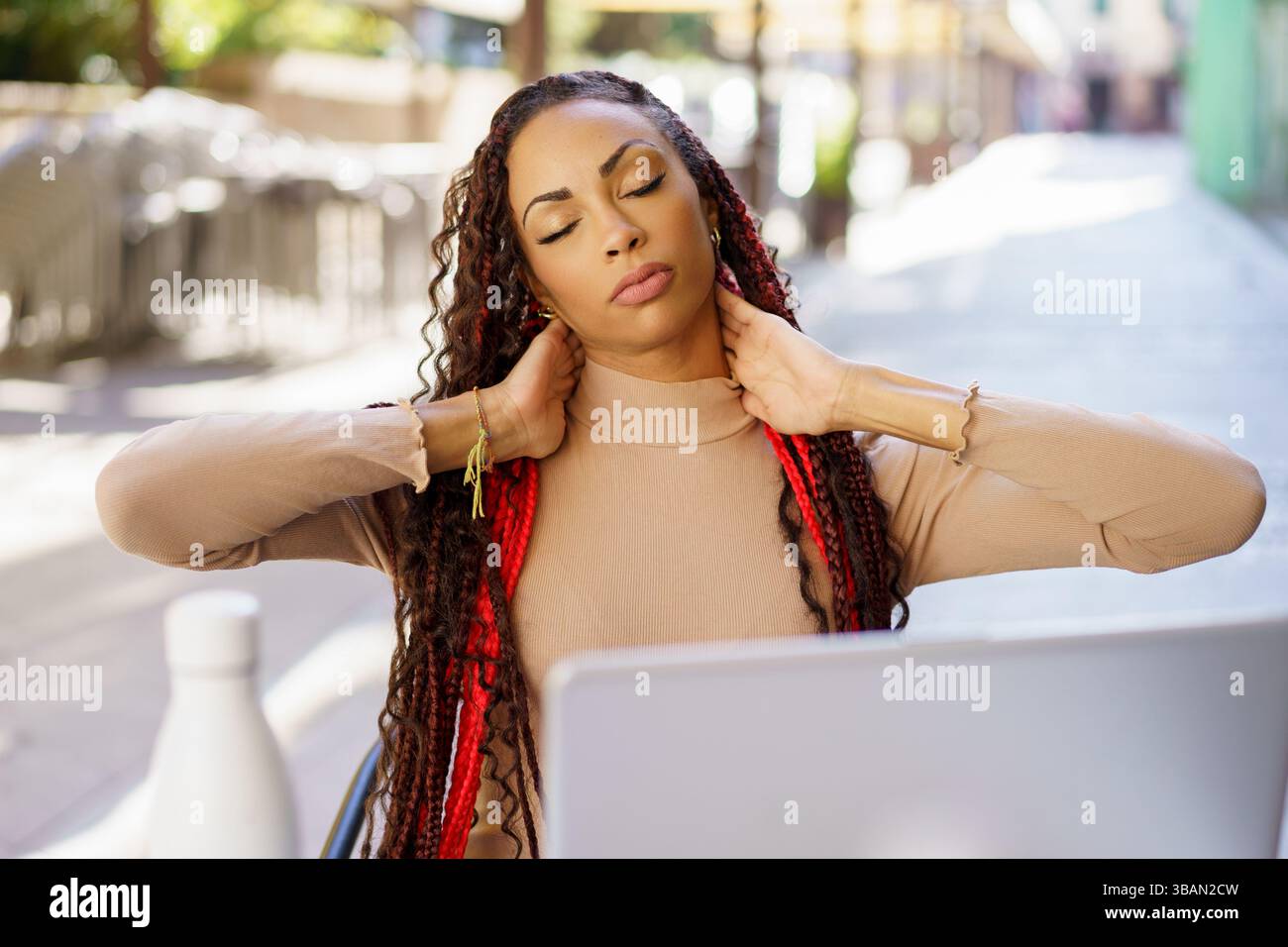 A Stressed Woman Engaging in Stretching Exercises at an Outdoor Cafe ...