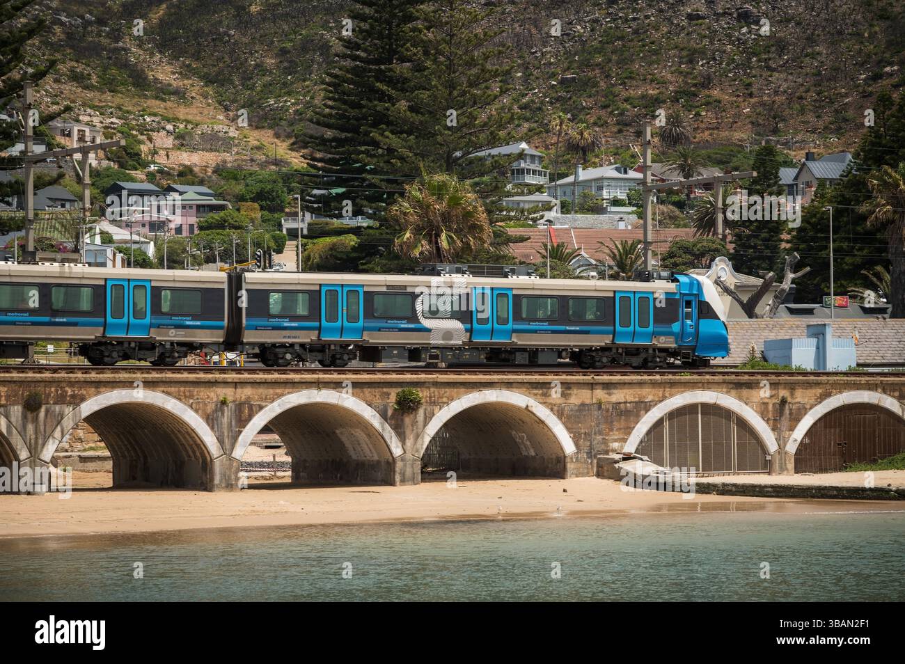 The train from Cape Town rolls through Kalk Bay resort, on the shores ...
