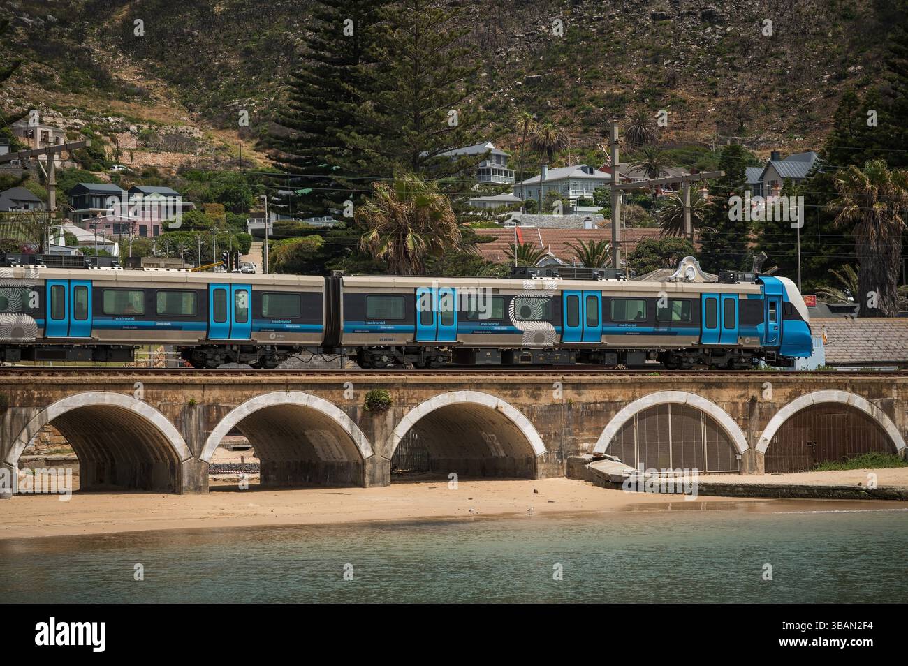 The train from Cape Town rolls through Kalk Bay resort, on the shores ...