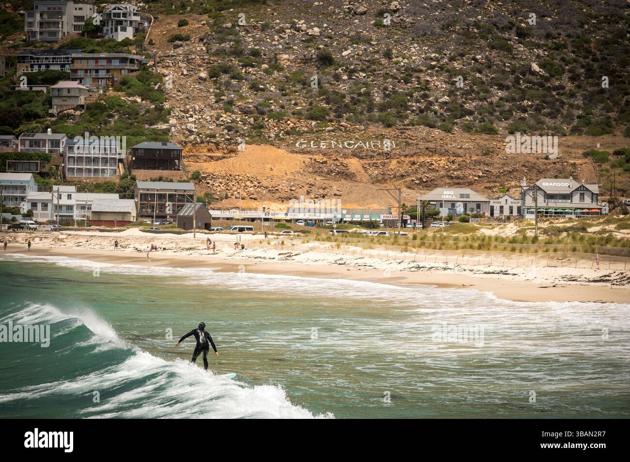 Surfers off of Glencairn Beach, on the shores of False Bay, east of ...