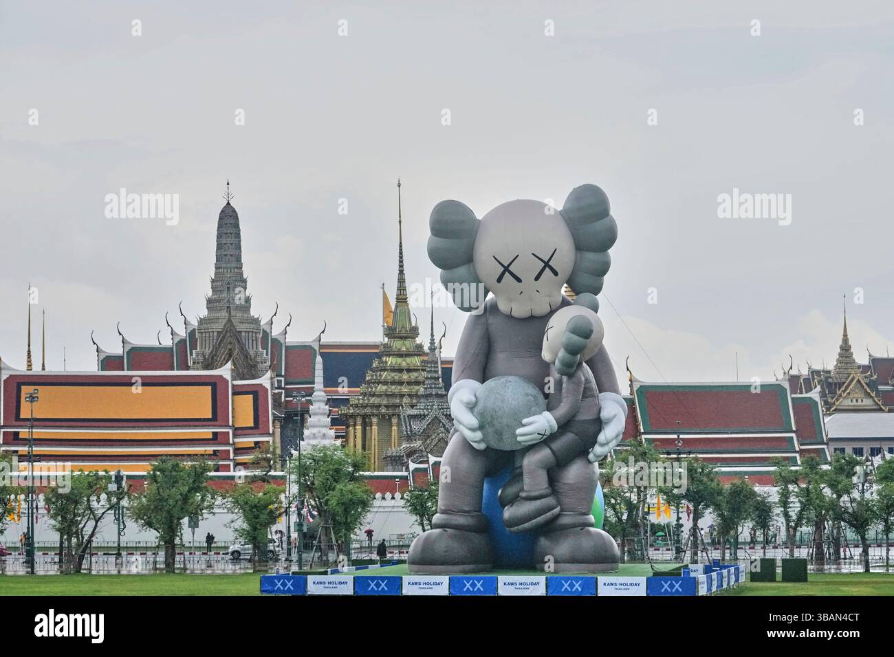 A sculpture of "KAWS" stands in front of grand palace as a part of a ...