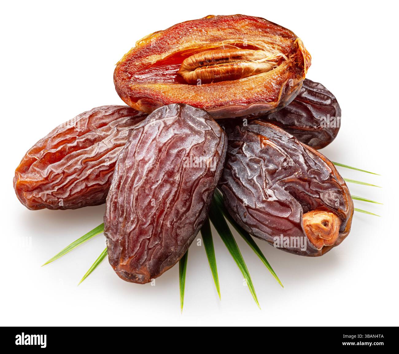 Semi-dried dates or date palm fruits lie on palm leaves isolated on ...
