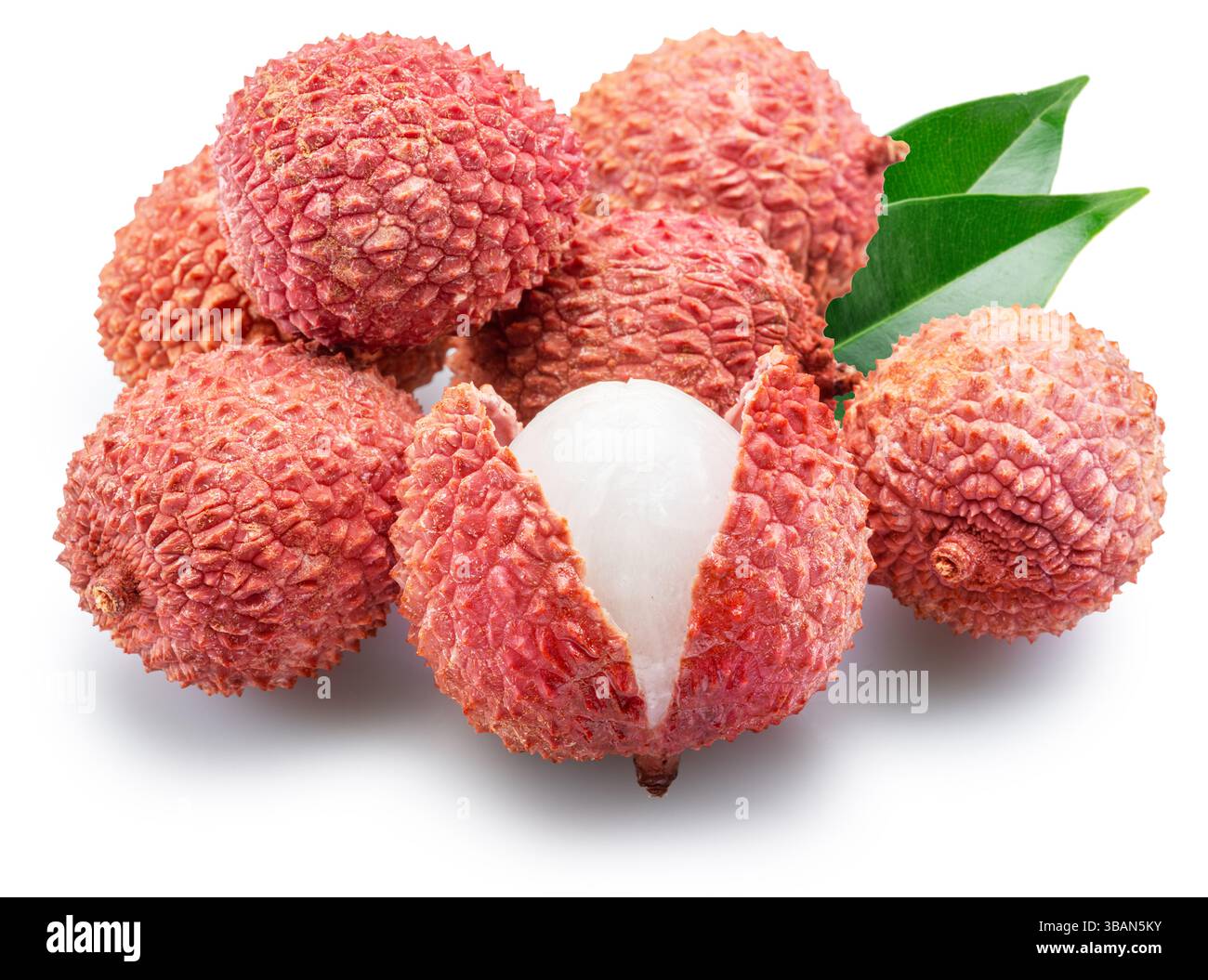 Lychee fruits with green leaves and one lychee peeled in half isolated ...