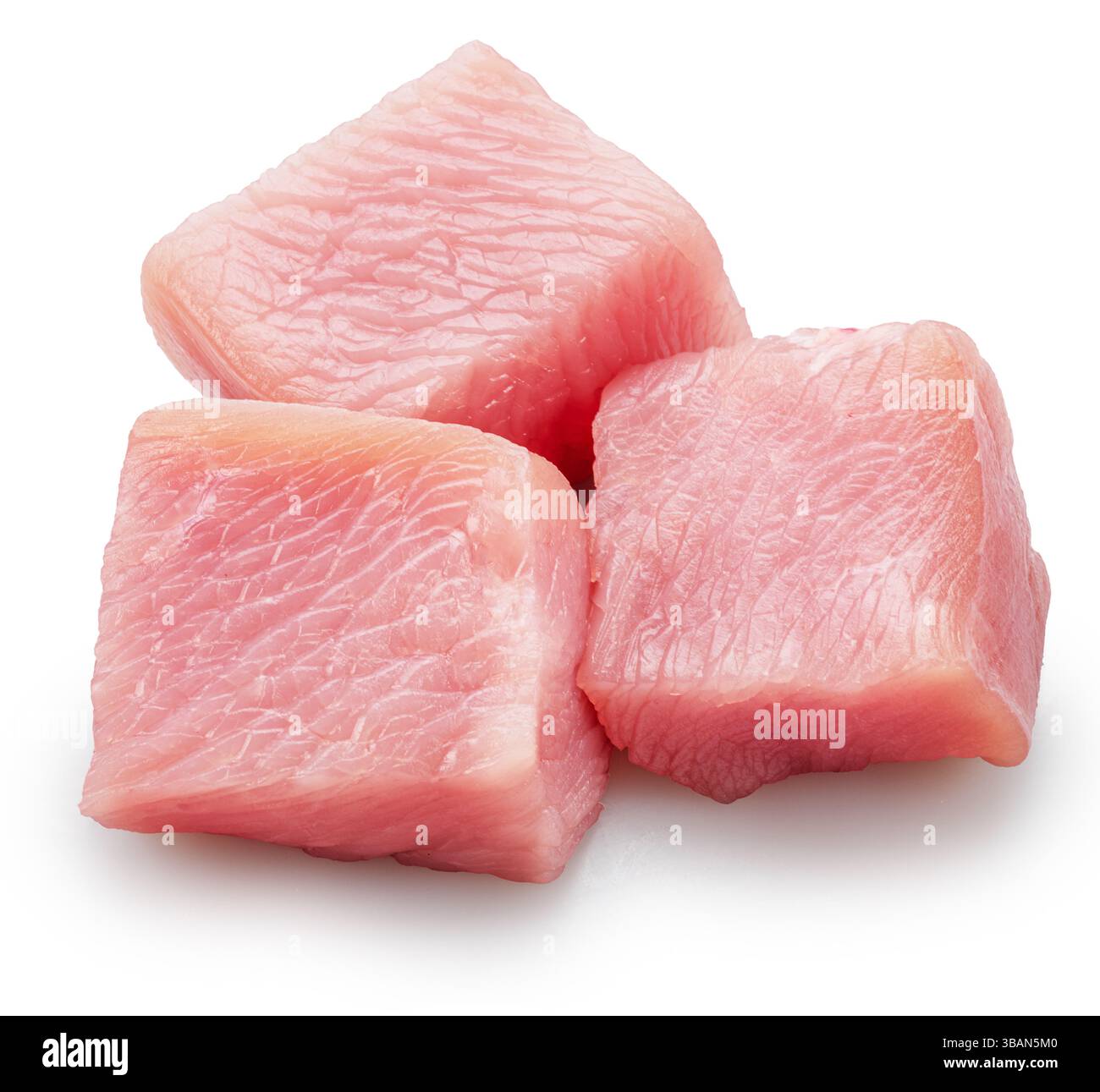 Three turkey meat cubes isolated on white. File contains clipping paths ...