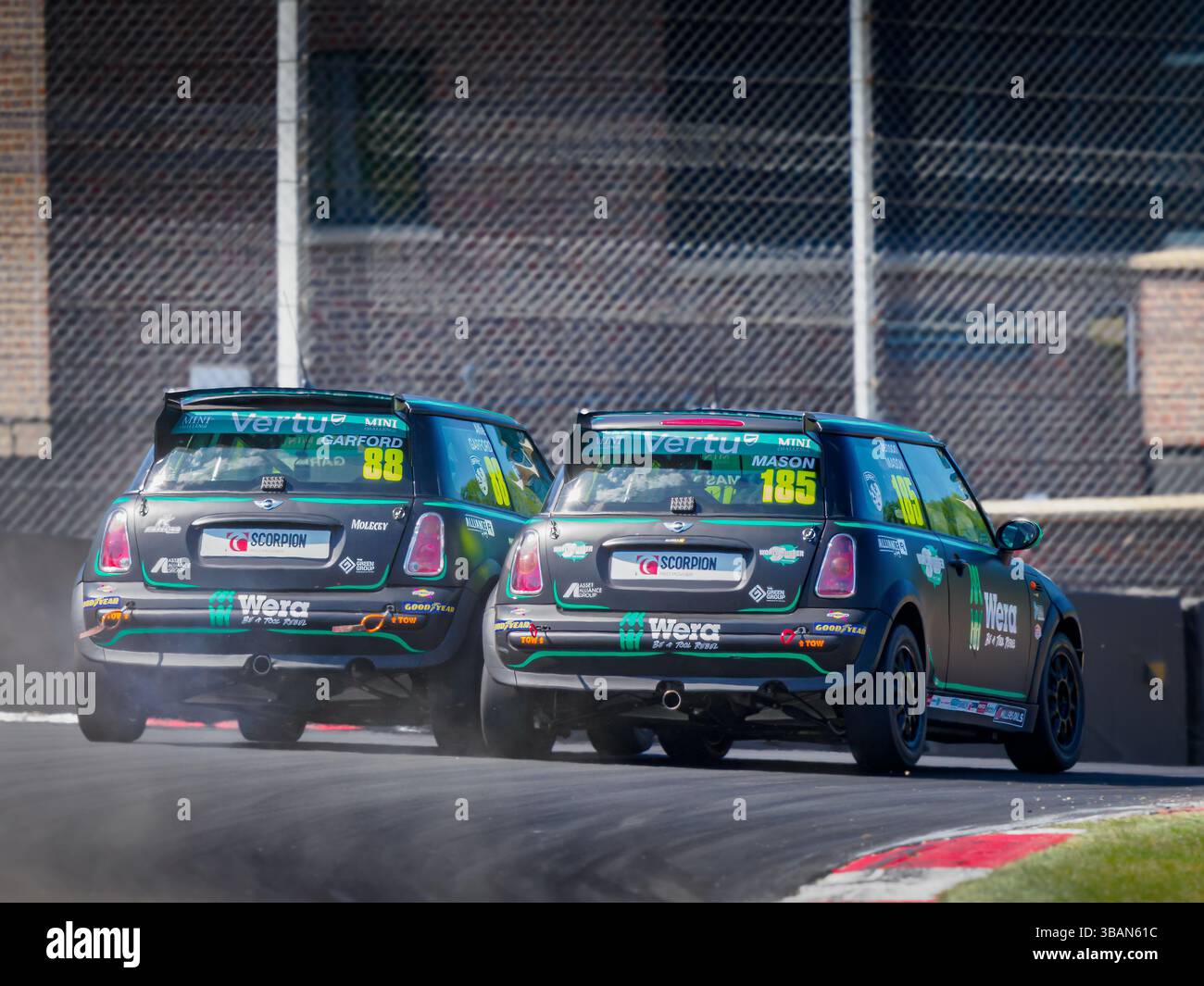 A pair of Mini Coopers racing in the Vertu MINI CHALLENGE Trophy race ...