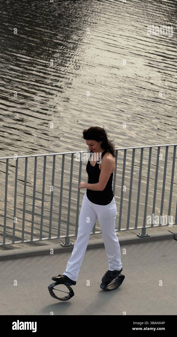 A fit woman enjoys an outdoor cardio workout, using rebound shoes for ...