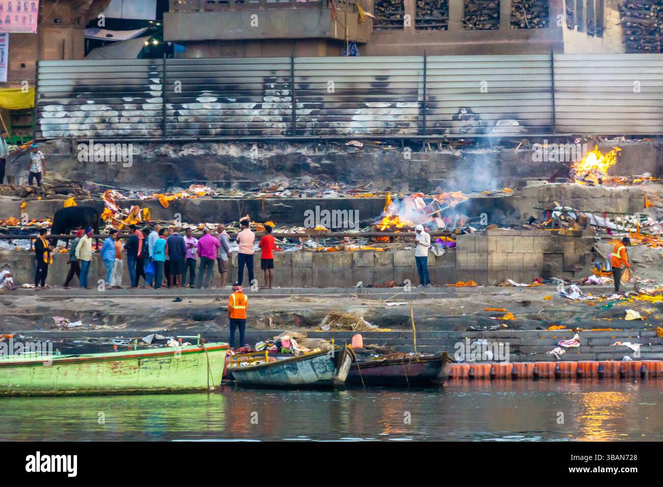 Funeral pyres by banks of Ganges River in Varanasy, India Stock Photo ...