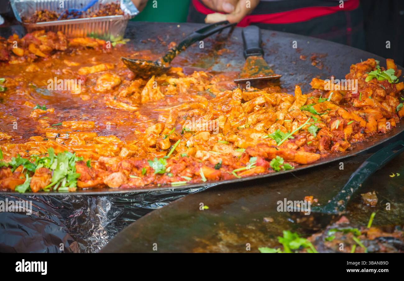 Chinese style chicken fry displayed in a big wok at Brick Lane market ...
