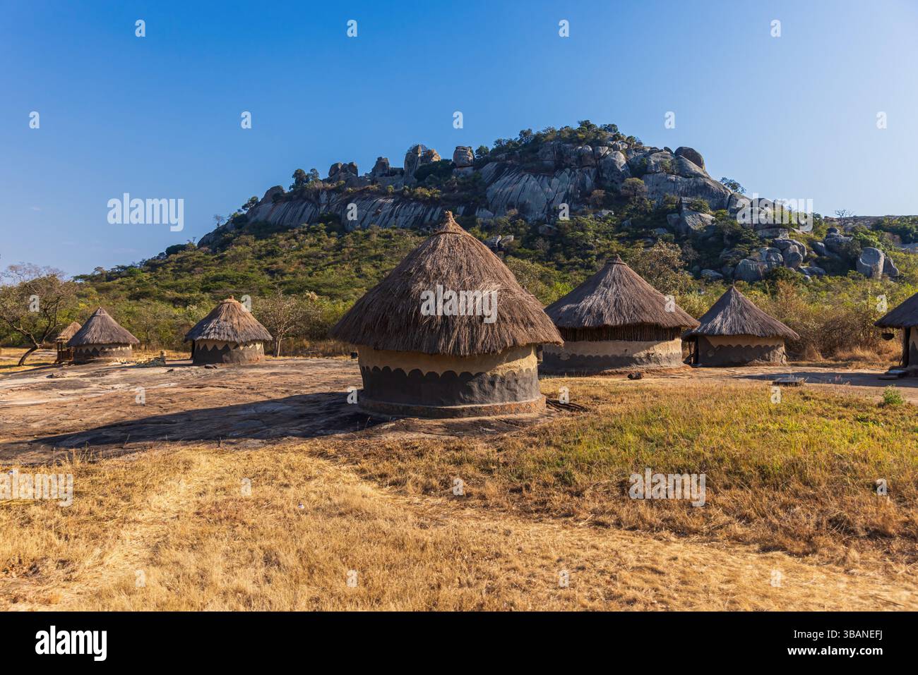 Traditional Huts in Front of Hill Complex - Great Zimbabwe Stock Photo ...