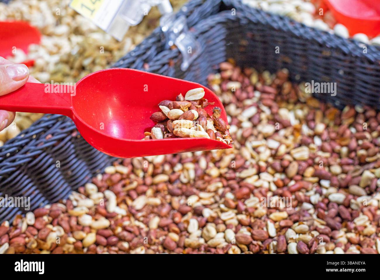 pick up peanuts in a bucket in a supermarket Stock Photo - Alamy