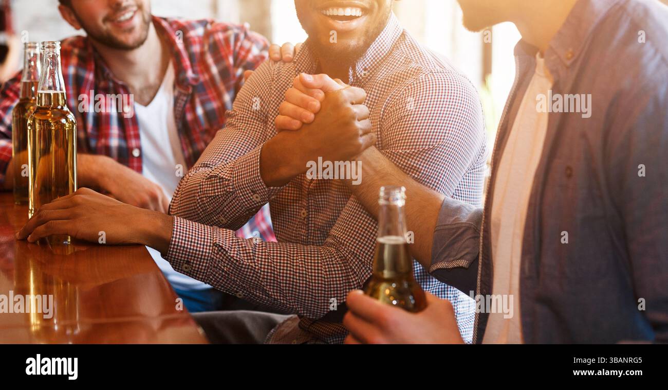 Men Greeting. Friends Shaking Hands And Driking Beer In Pub Stock Photo ...