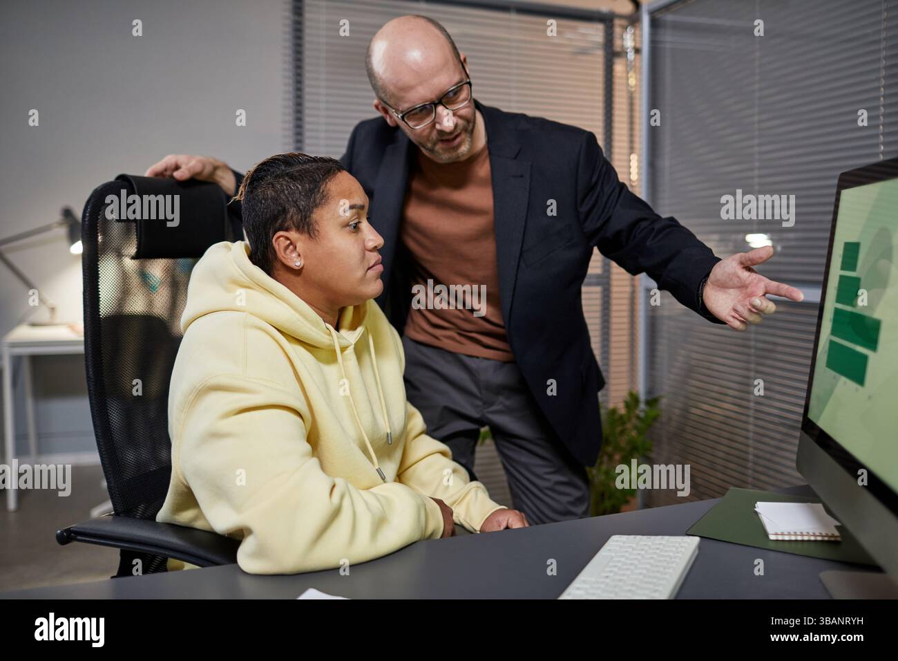 Side view portrait of mature business manager instructing female ...
