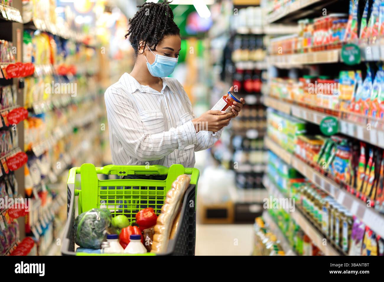 Black Woman Checking Expiration Date On Food Product Doing Grocery ...