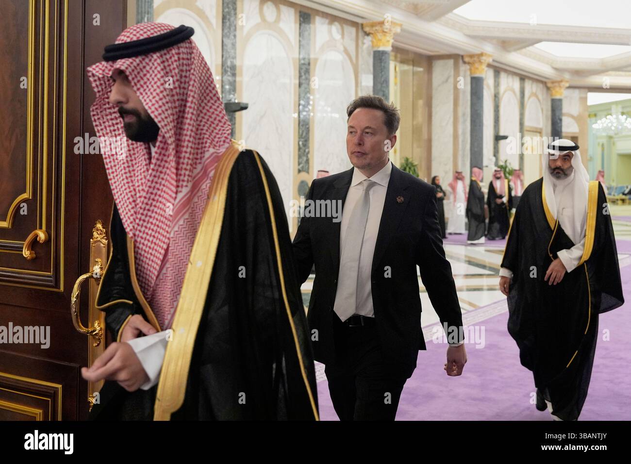 Elon Musk, center, departs a luncheon hosted by Saudi Crown Prince ...