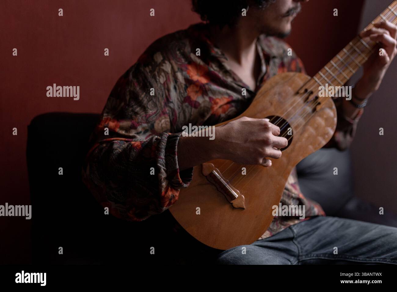 A young Native American musician is playing with his jarana guitar at ...