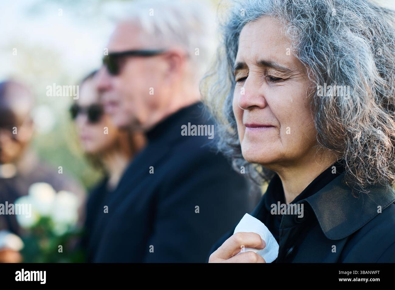 Mature crying woman with tears on her cheek lamenting her relative ...