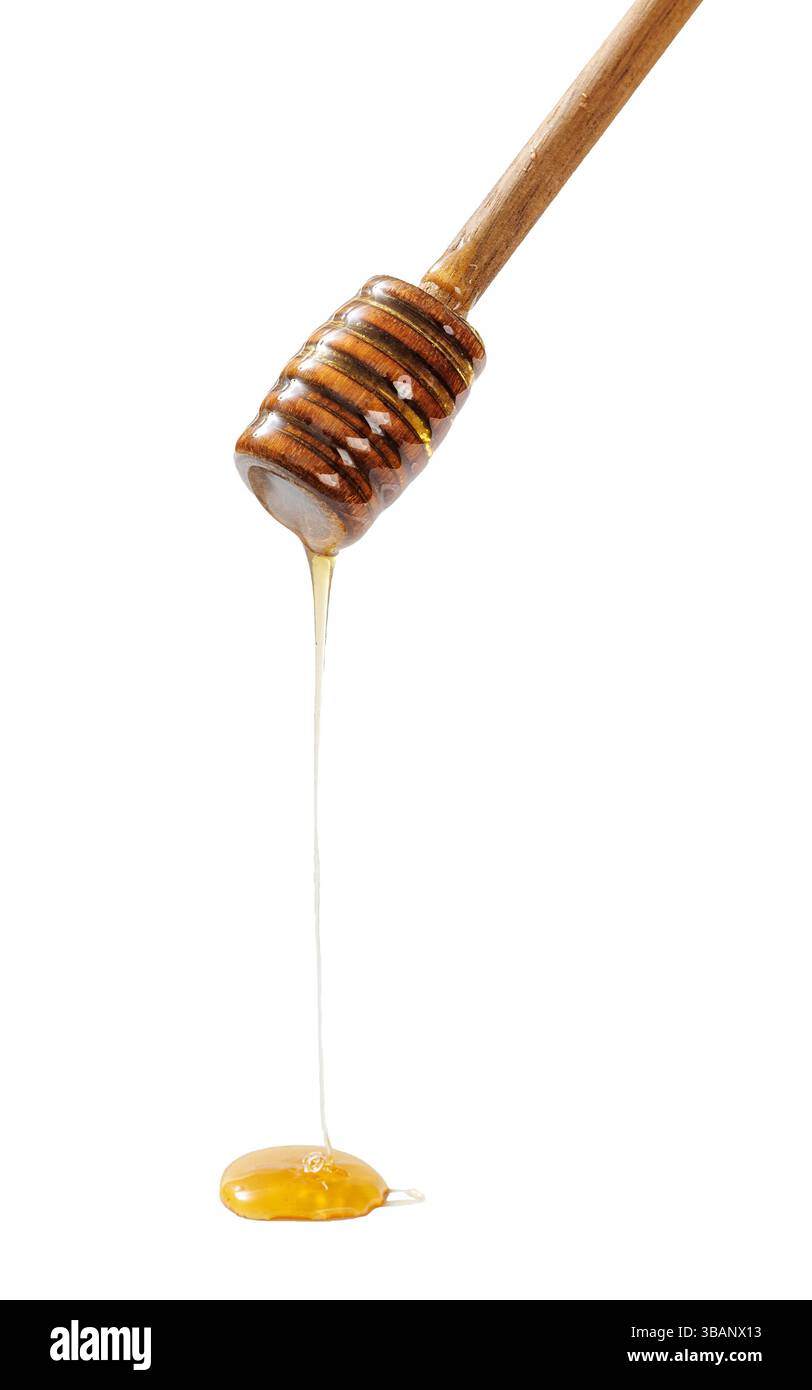 a wooden honey handmade spoon with golden honey dripping on white ...