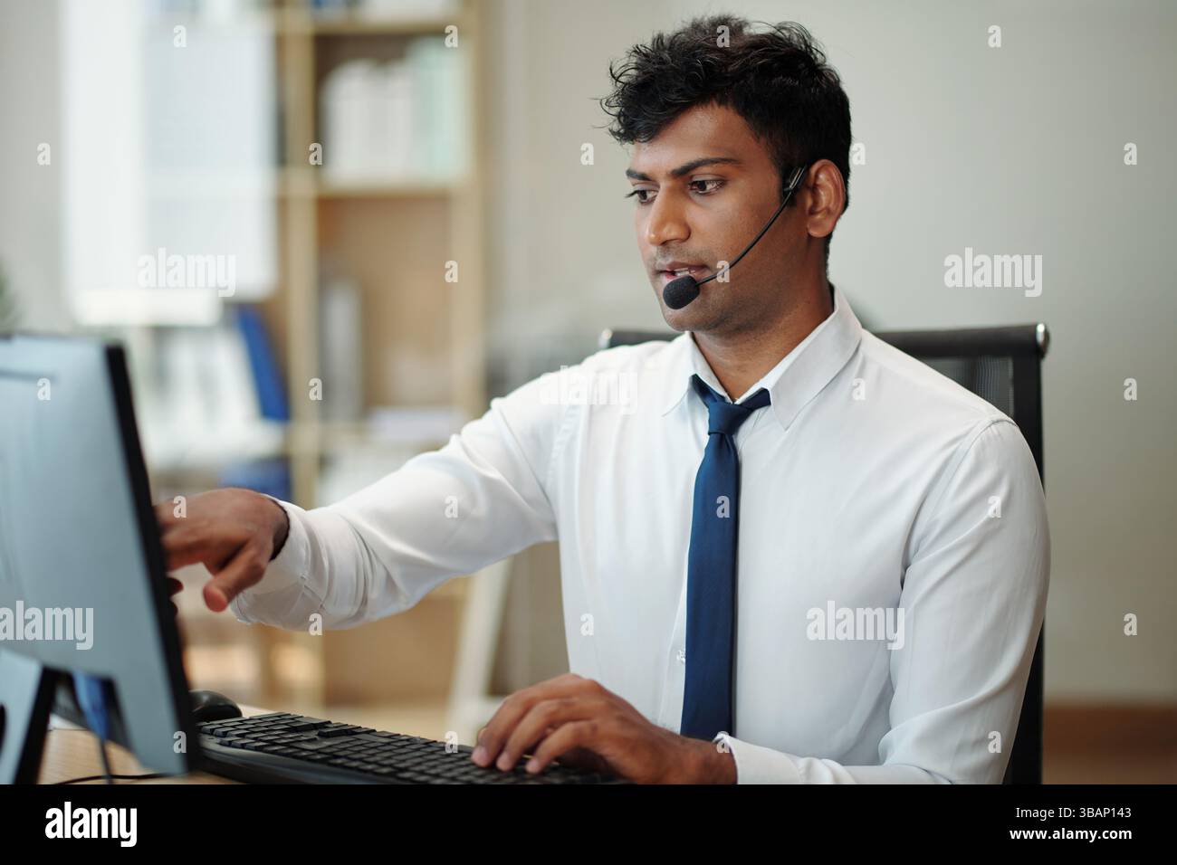Security officer pointing at computer screen when checking surveillance ...
