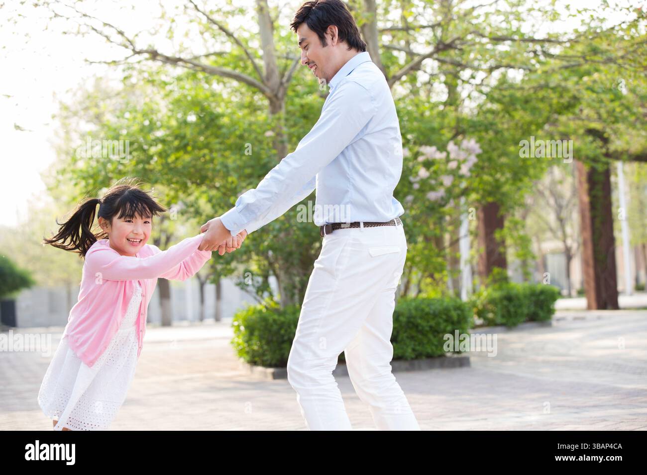 Happy Chinese father and daughter playing Stock Photo - Alamy