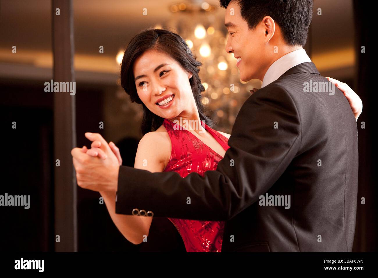 Young Chinese couple dancing in a luxurious room Stock Photo - Alamy