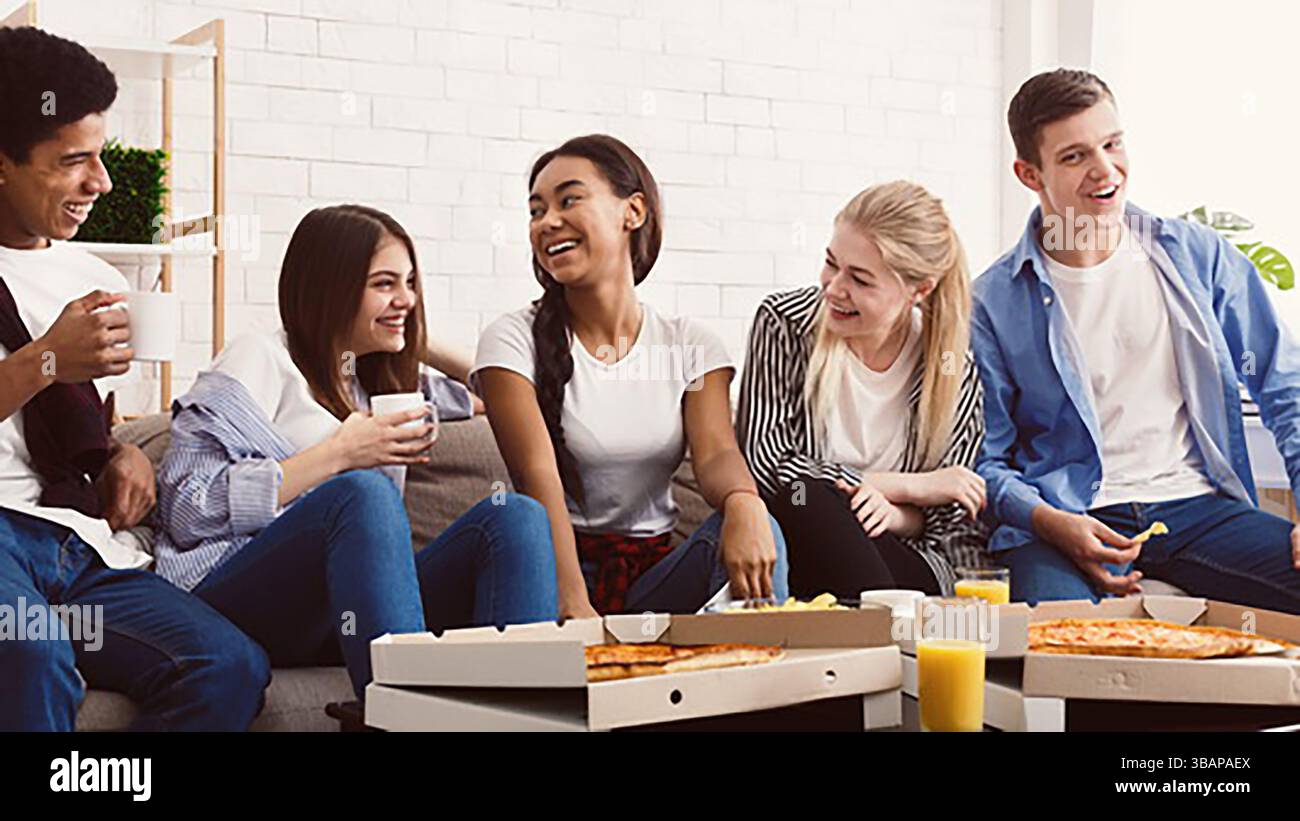 Happy Diverse group of friends having pizza party sitting on the couch ...