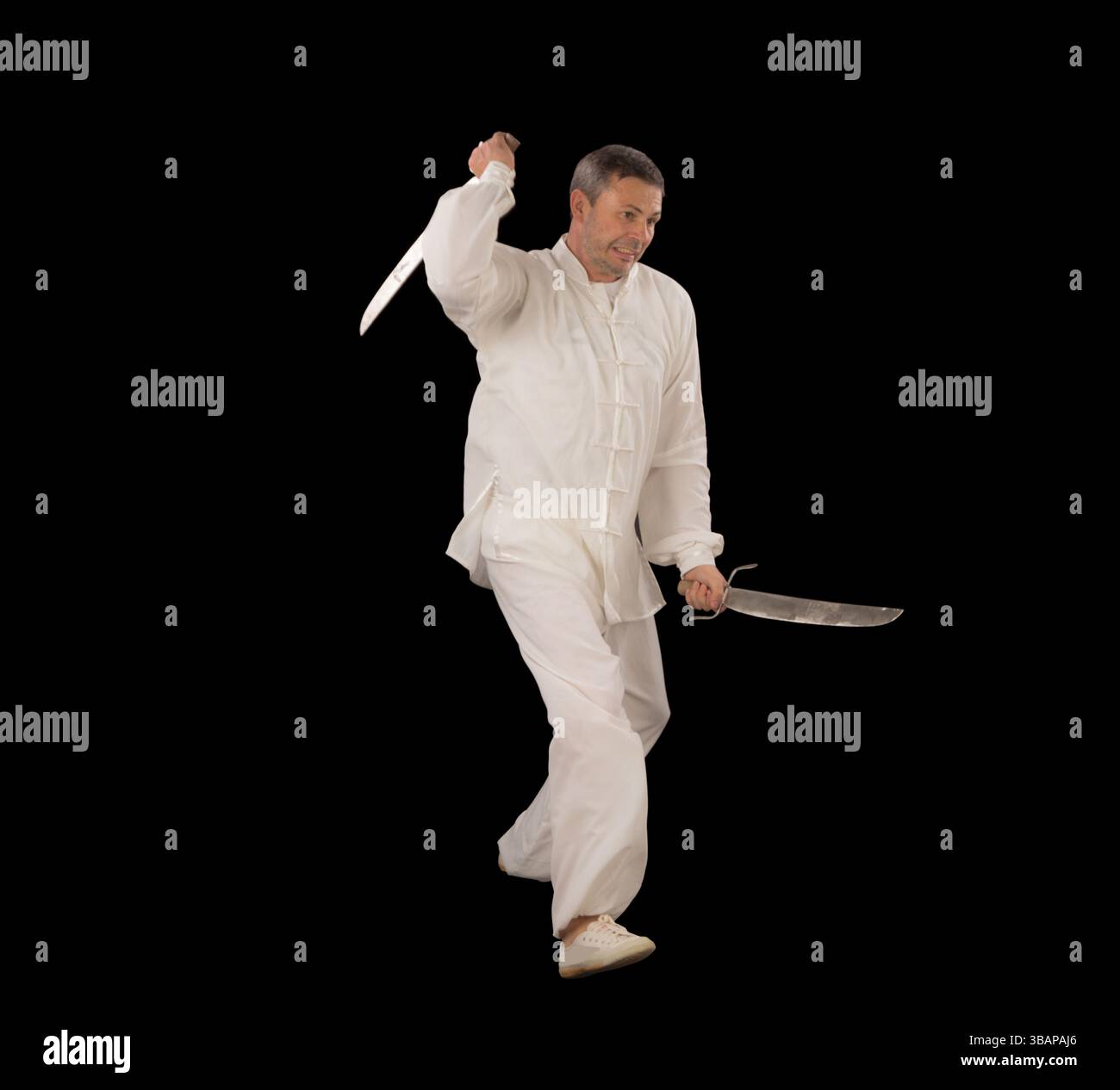 Man wearing all white with two swords Stock Photo - Alamy