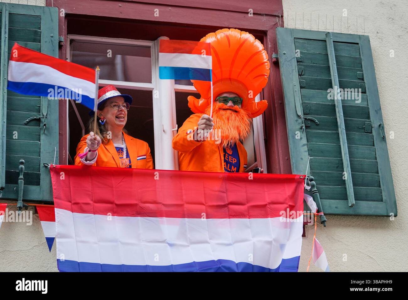 Dutch Eurovision fans celebrate out of an apartment window in the city ...