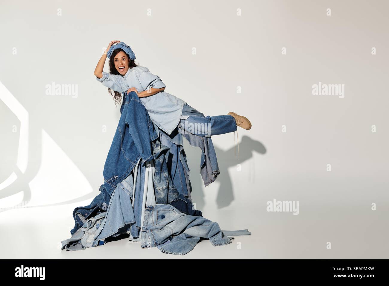 A joyful young woman models playful summer fashion using a creative ...