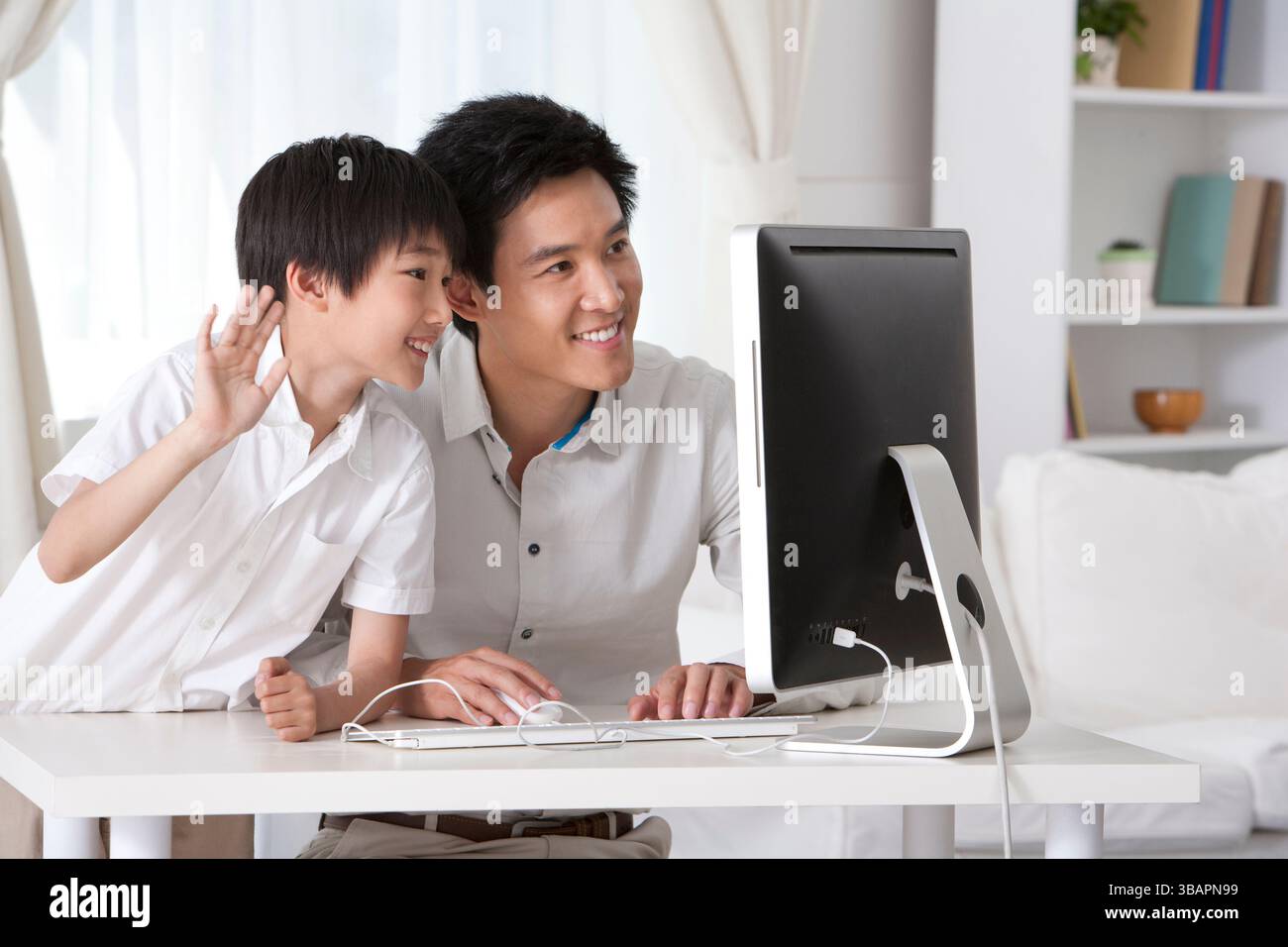 Chinese father and son video chatting Stock Photo - Alamy