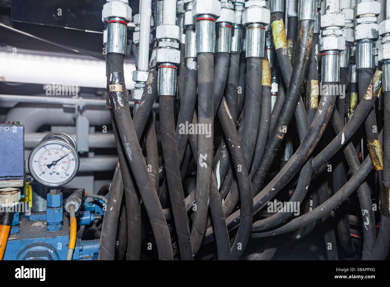 High pressure hydraulic hose system connected to steel pipes, close-up ...