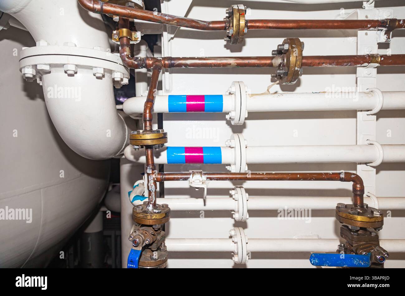 Ship's piping system with white painted steel pipes and copper pipes ...