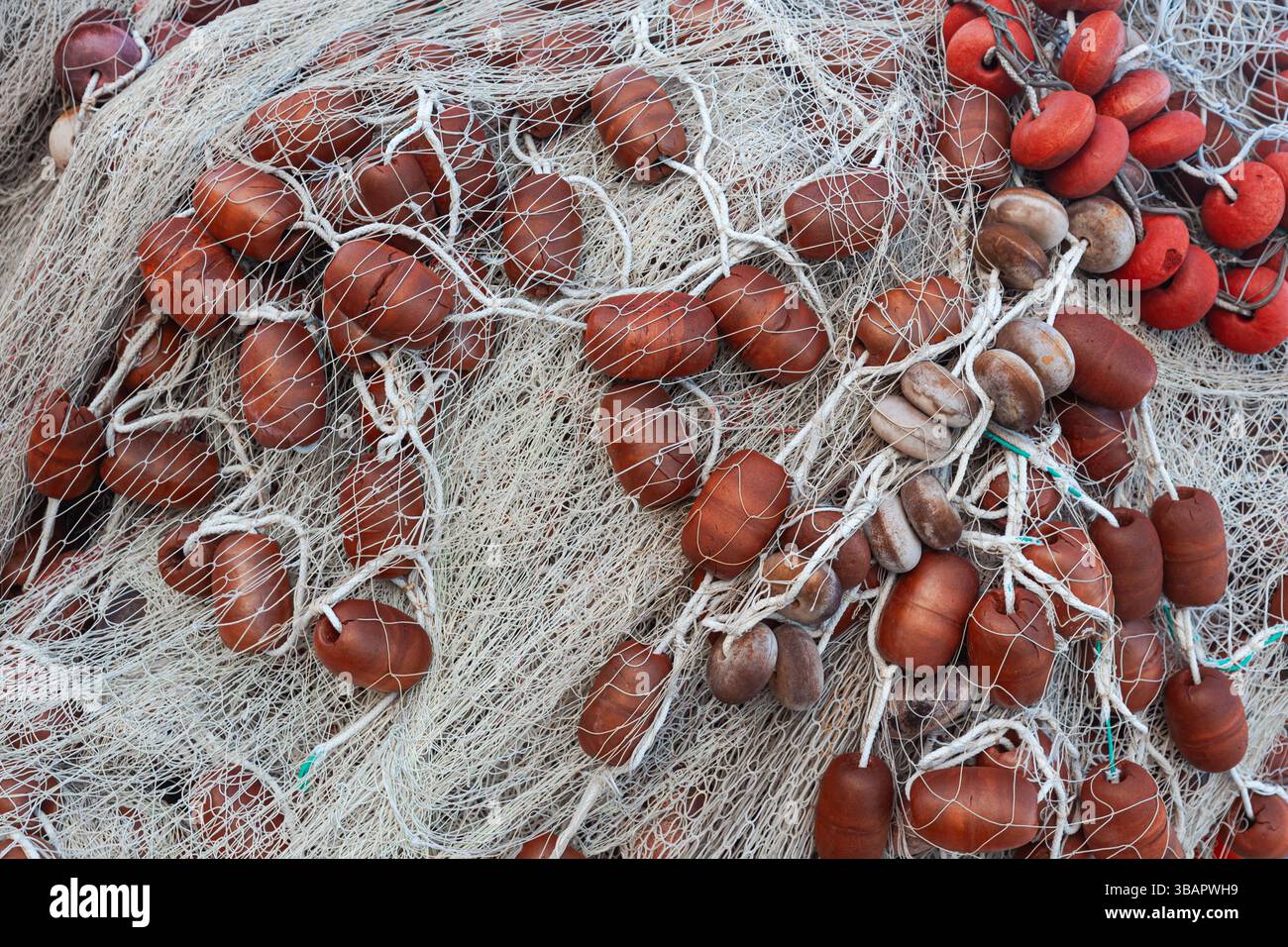 Large pile of fishing nets with floats Stock Photo - Alamy