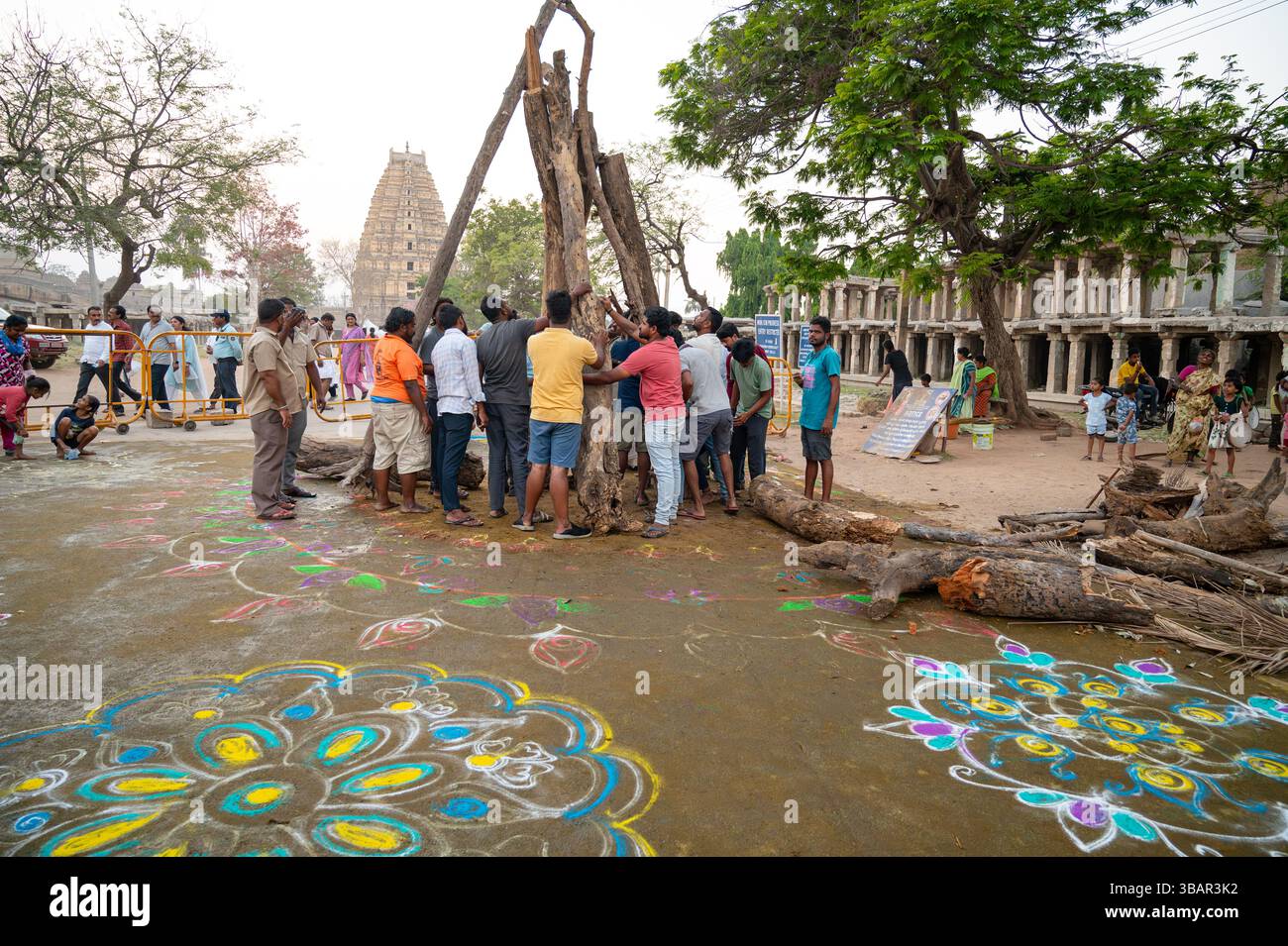 Holika Dahan, men collect wood for ritual bonfire, Kolam colorful ...