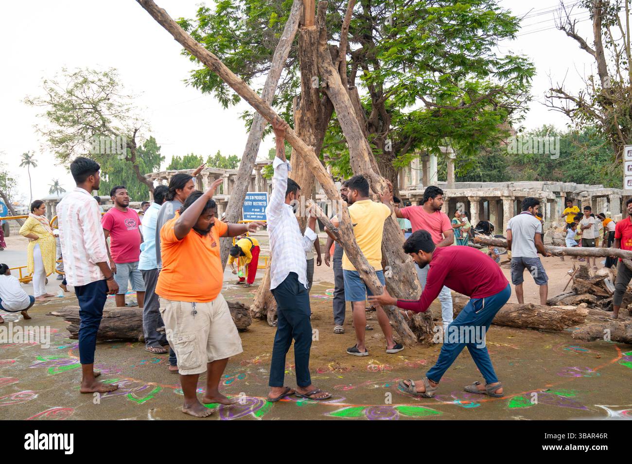 Holika Dahan, men collect wood for ritual bonfire, Kolam colorful ...