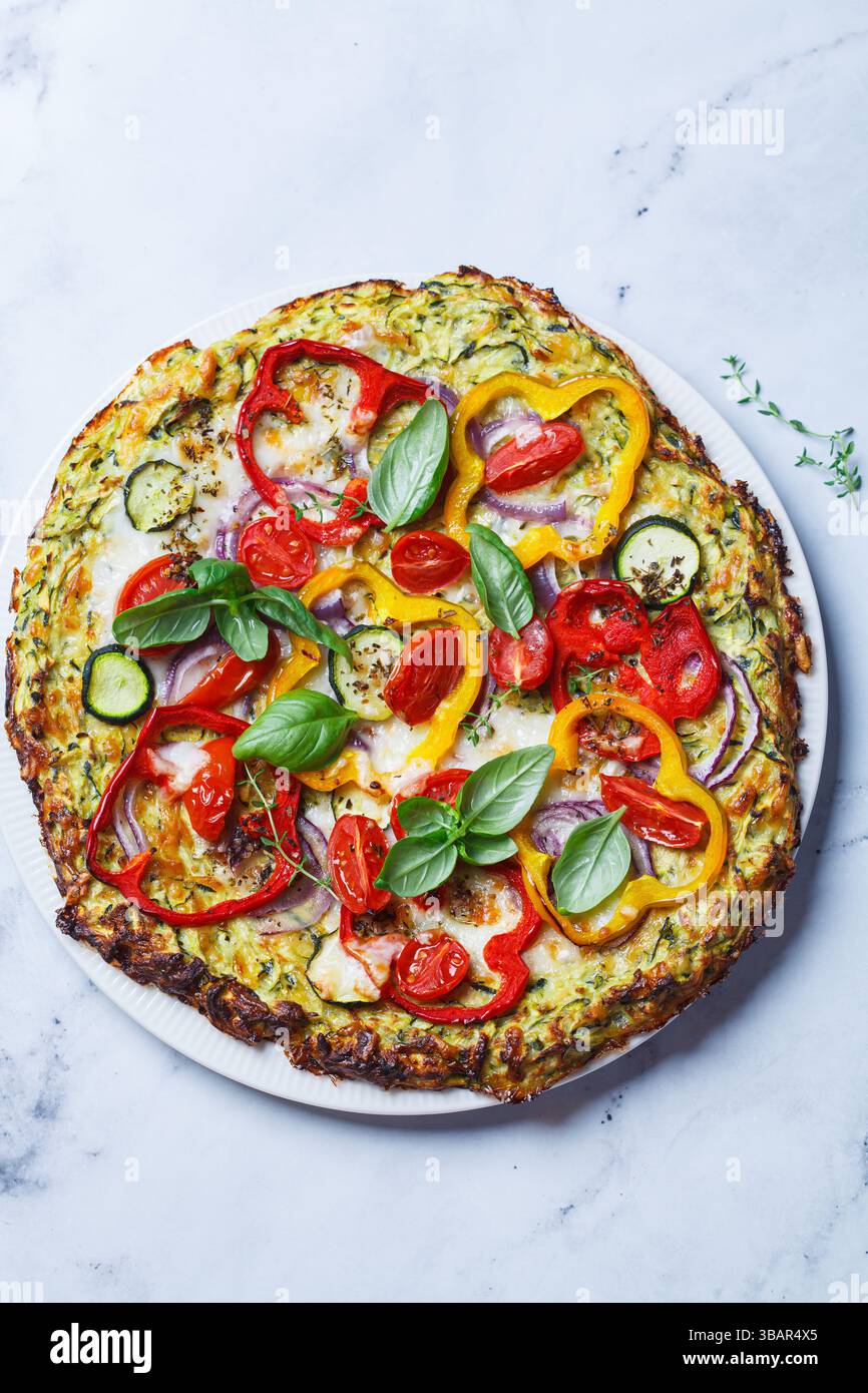 Plant-based pizza on zucchini crust with vegetables and vegan ...