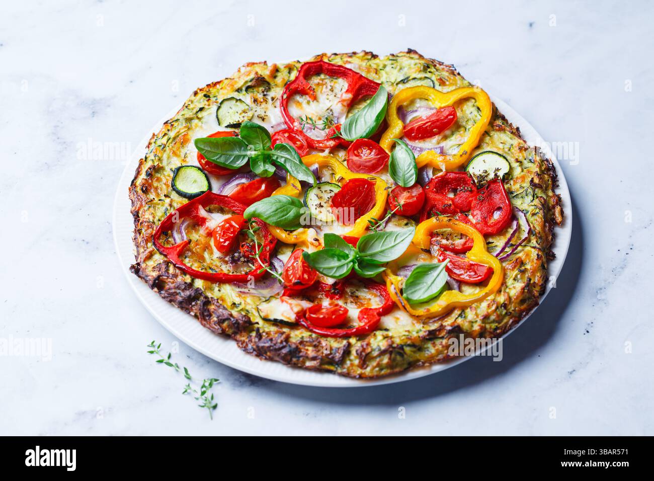 Plant-based pizza on zucchini crust with vegetables and vegan ...