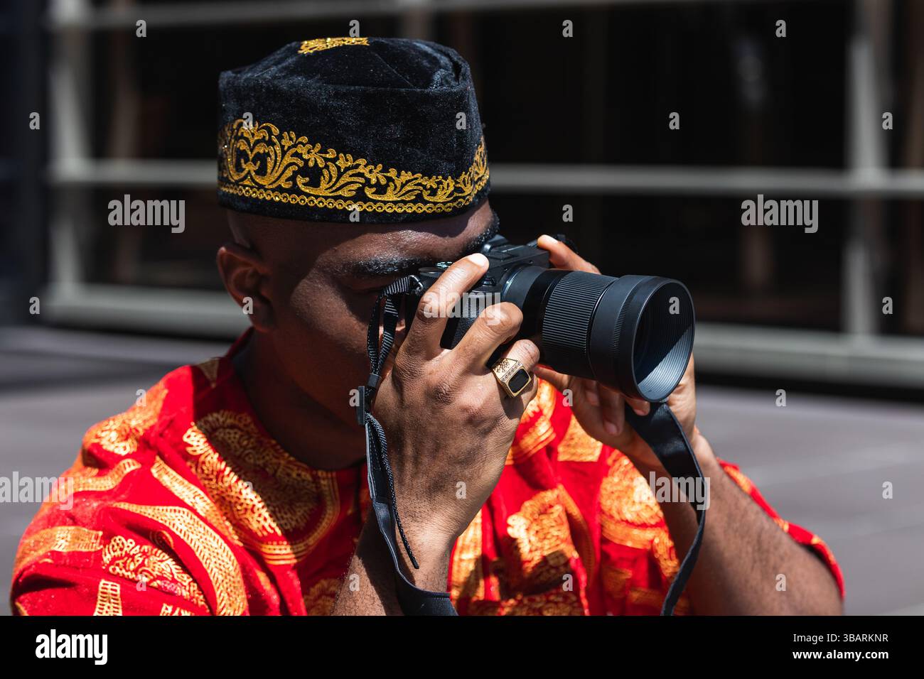 Black man photographer takes photographs with mirrorless camera in a ...