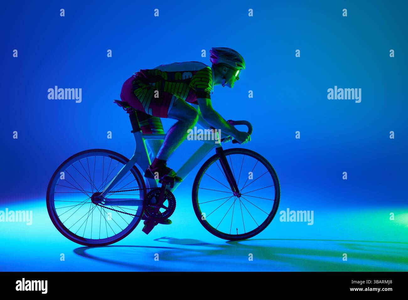 Side view image of male cyclist in full gear, riding bicycle, training ...