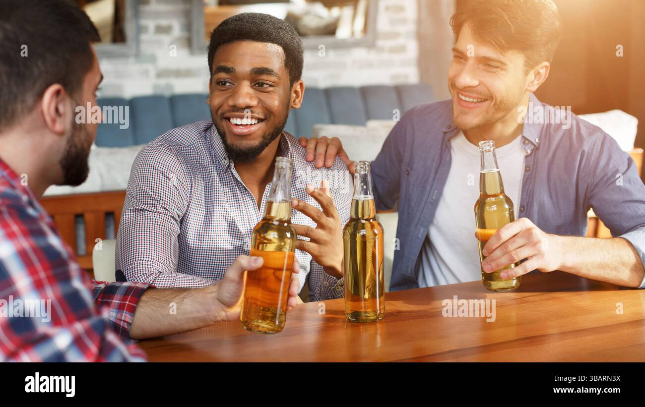 Meeting In Bar. Best Friends Talking And Drinking Beer In Pub Together ...